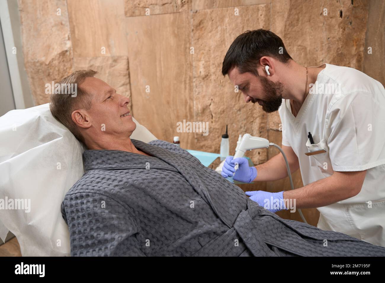 Man enjoying shockwave therapy session with his trusted medical ...
