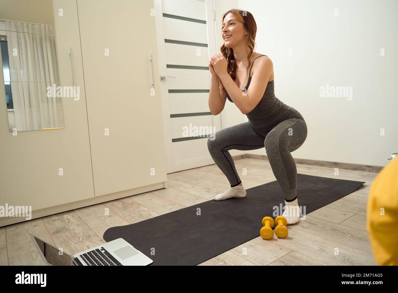 Joyful sporty lady doing lower-body workout at home Stock Photo - Alamy
