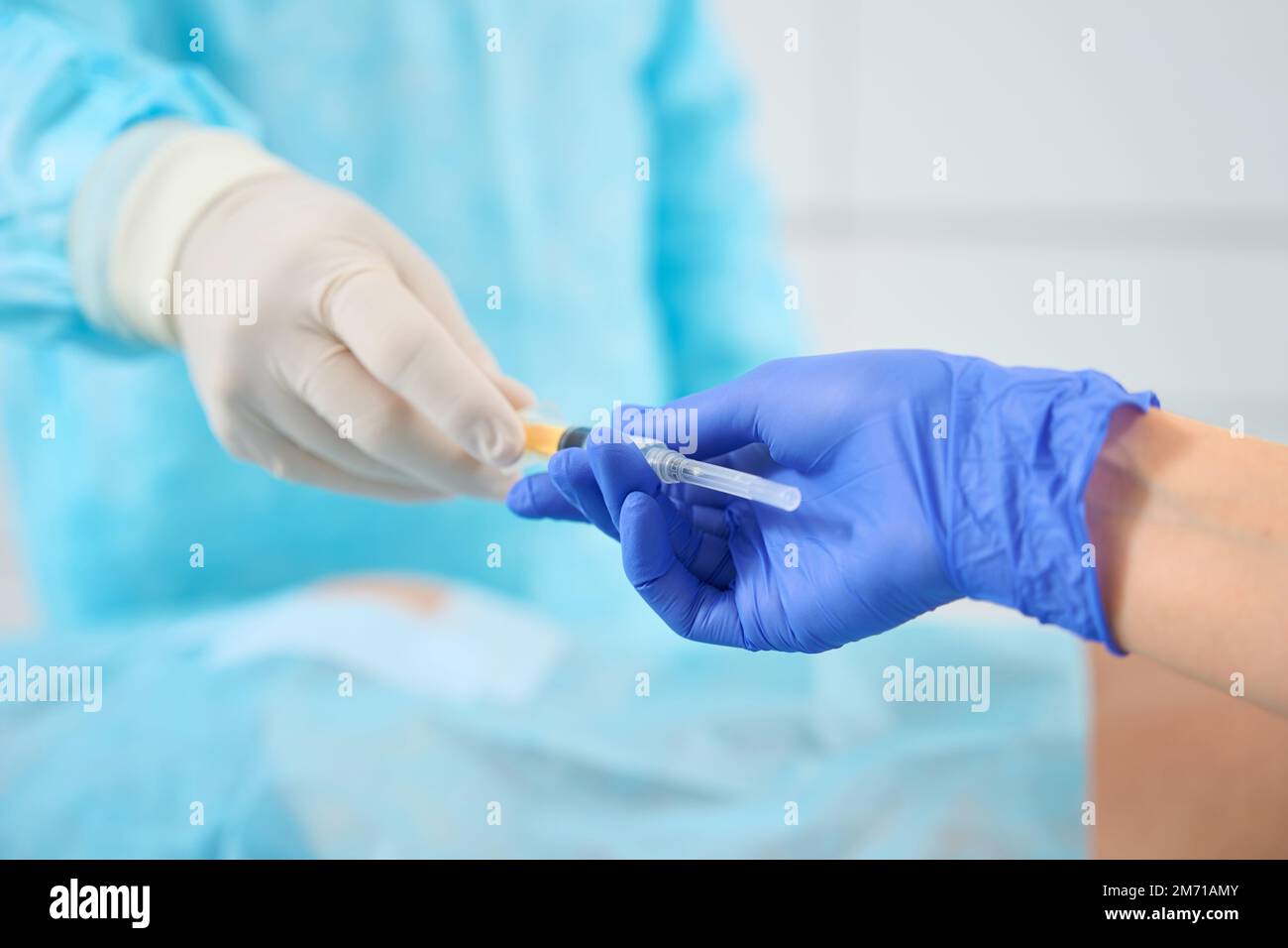 Close up of assistant gives the surgeon a syringe with medicine Stock ...