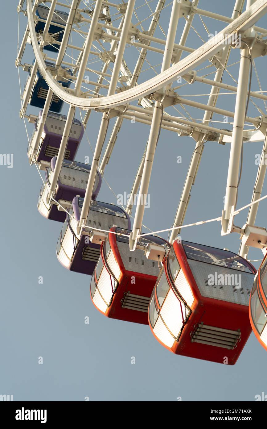 Colorful passenger cabins on modern Ferris wheel against blue sky Stock ...