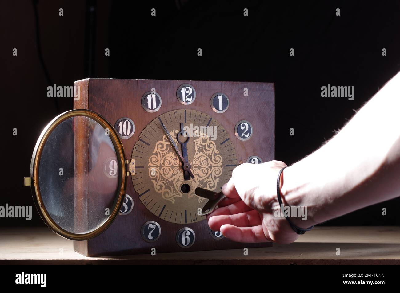 Start time with a key. Clockwork key in hand. Make time. Hand and key ...