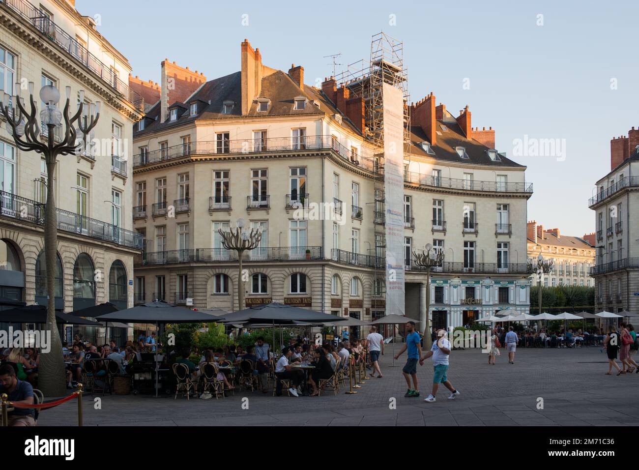 A beautiful shot of historic buildings and people walking around in ...