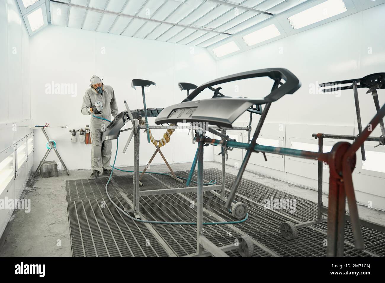 Worker doing color restoration for car parts Stock Photo - Alamy