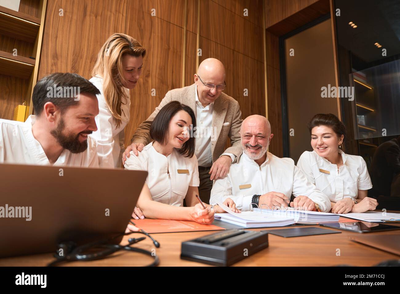 Group of smiling people in white coats is located in office Stock Photo ...