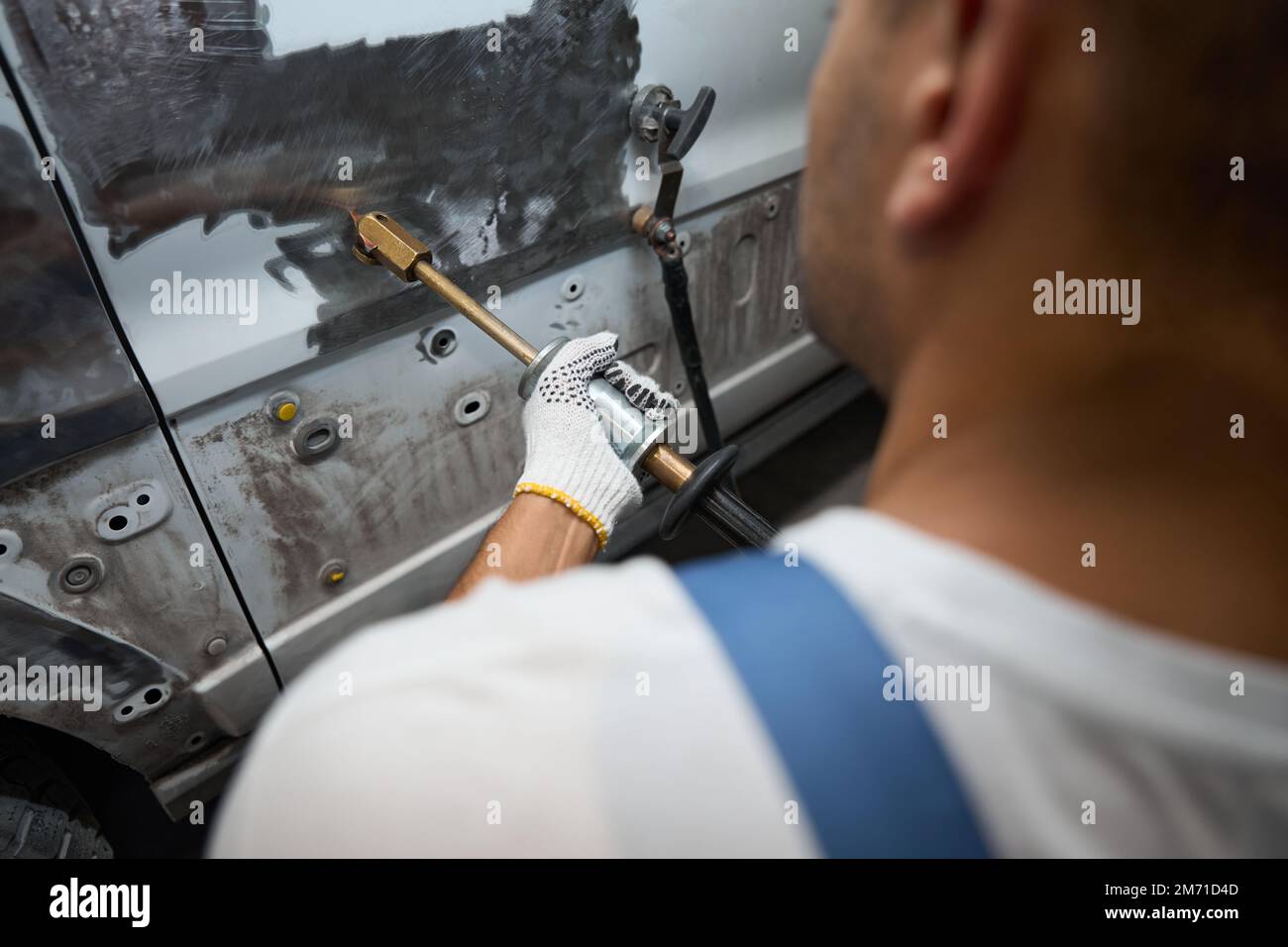 Male cleaning surface before applying new paint Stock Photo - Alamy