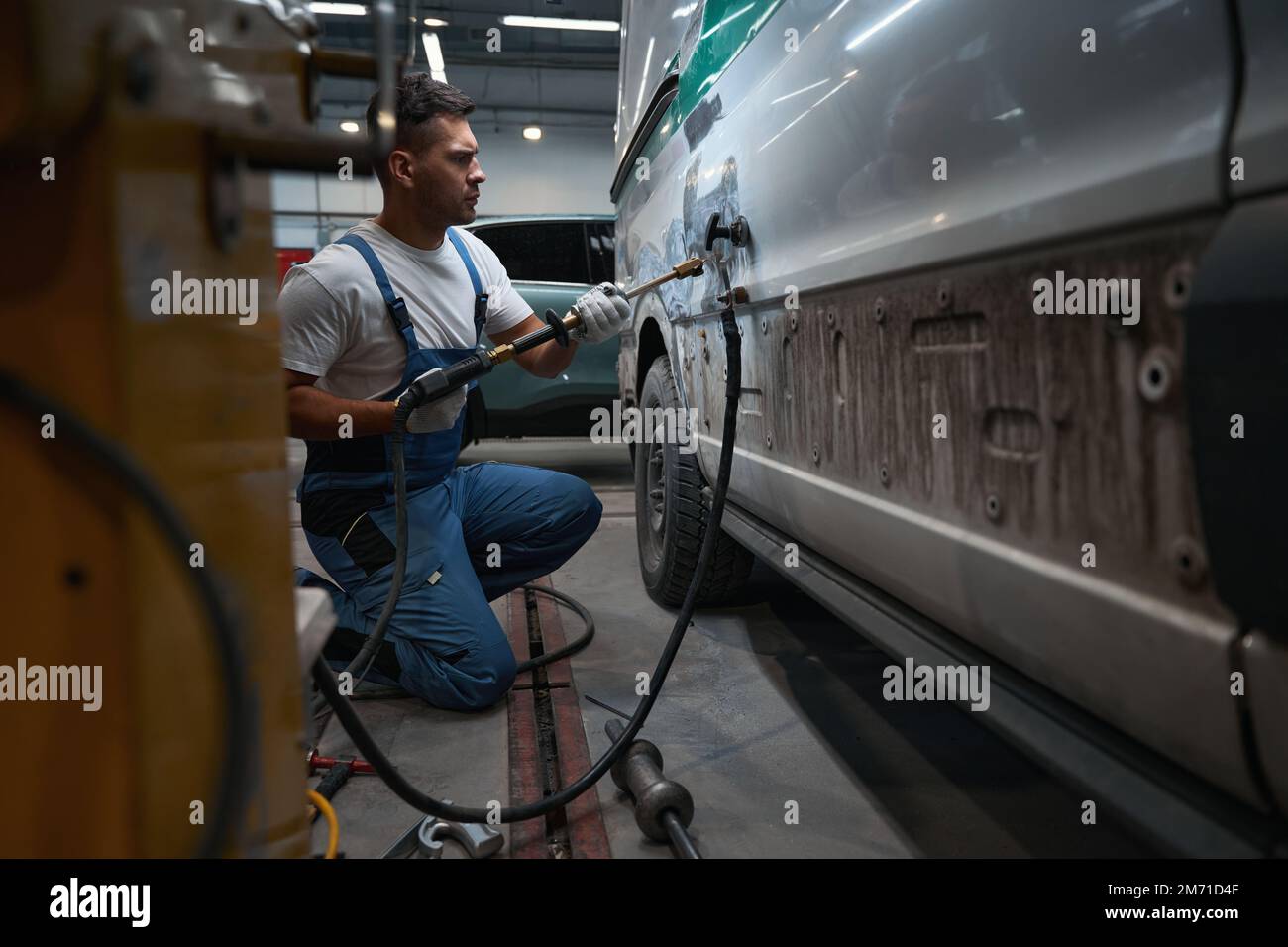 Man cleaning surface before applying new paint Stock Photo - Alamy