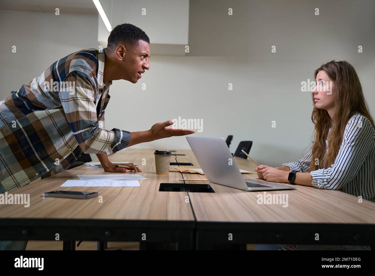 Dissatisfied guy arguing with his female colleague in the office Stock ...