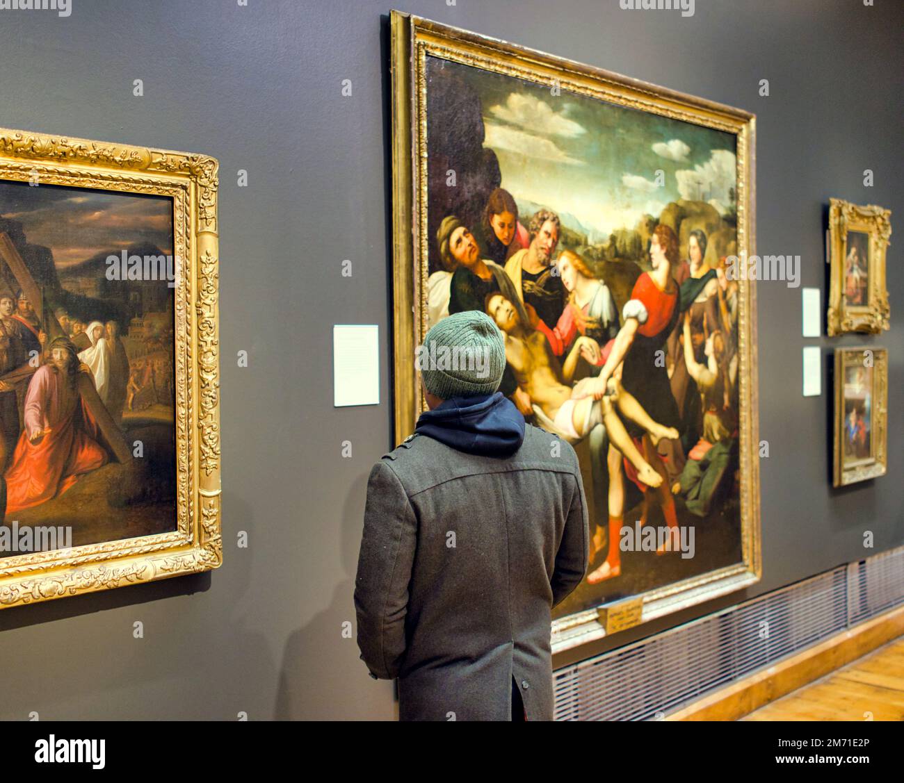 visitors admire the paintings in a gallery at in the hunterian art ...