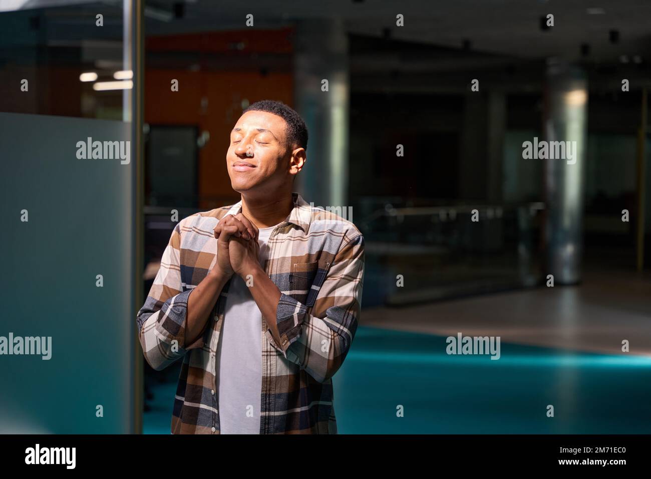 Man smiling hands in prayer hi-res stock photography and images - Alamy