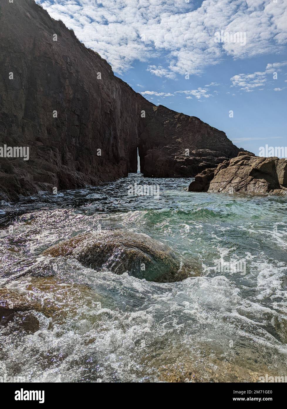 Sea water rushing over rocks Stock Photo - Alamy