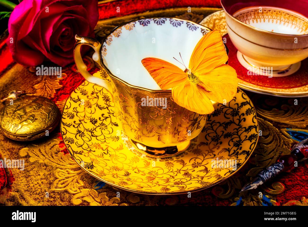 Tea Cup With Yellow Butterfly Stock Photo - Alamy