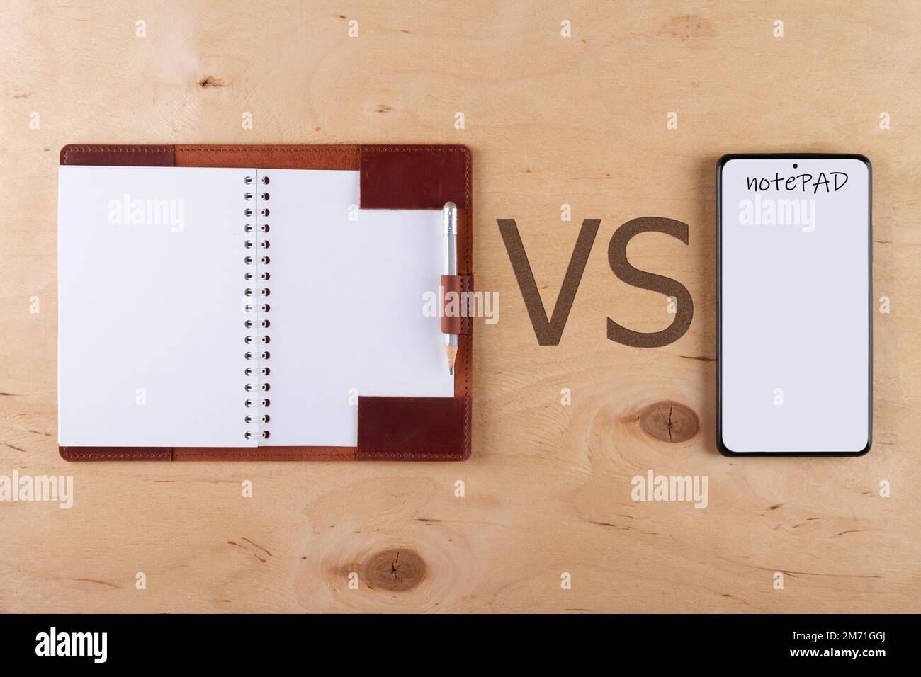Digitalization concept. Paper notebook vs smartphone. Digital phone ...