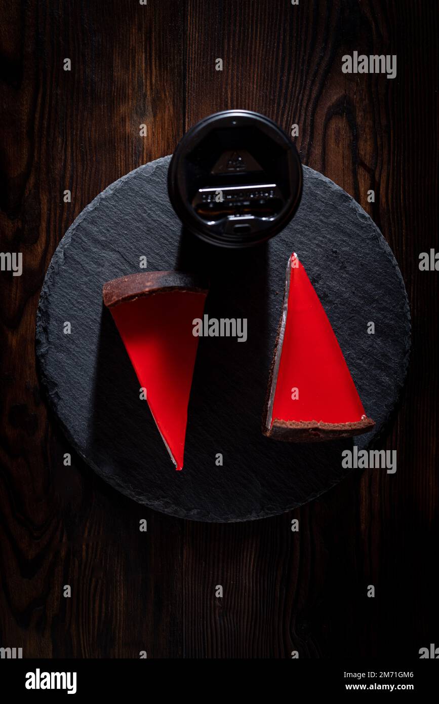 Bright red pieces of cake and coffee. Red and black. Dessert and coffee ...