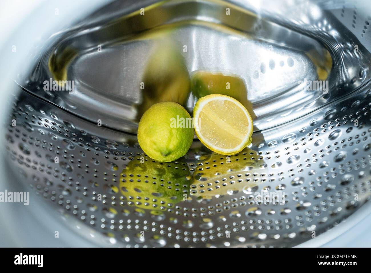 lemon inside washing machine. Half a lemon is placed on top of a whole ...