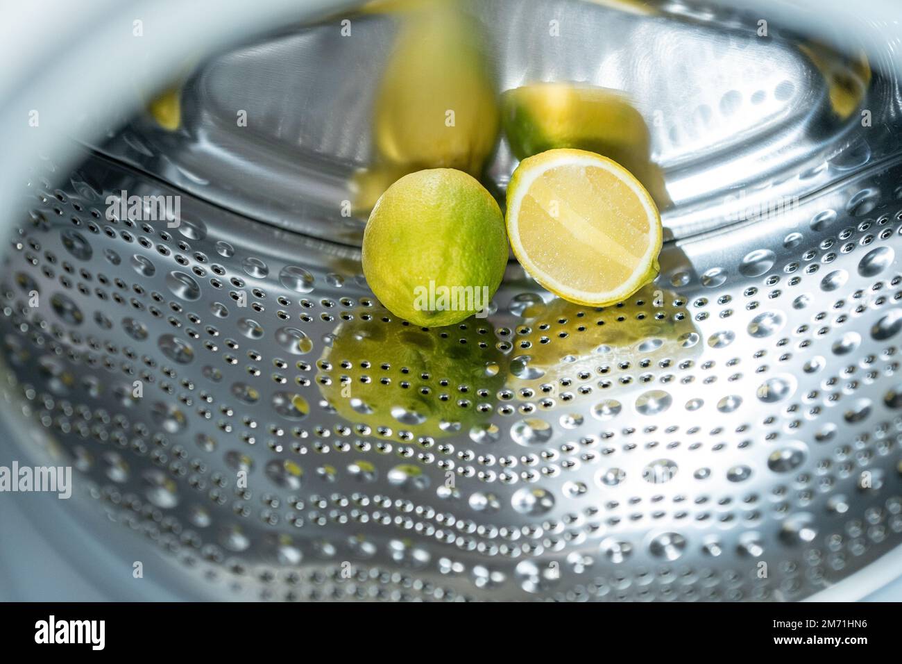 lemon inside washing machine. Half a lemon is placed on top of a whole ...