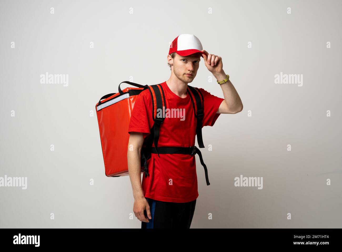 Delivery man in red uniform with thermal backpack for food. Takeaway ...
