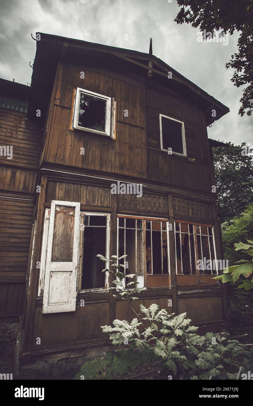 Old scary house against dark cloudy moody sky Stock Photo - Alamy
