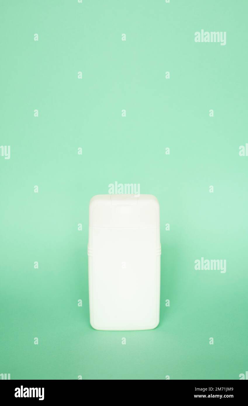 White square shampoo bottle or shower gel on pastel green background ...