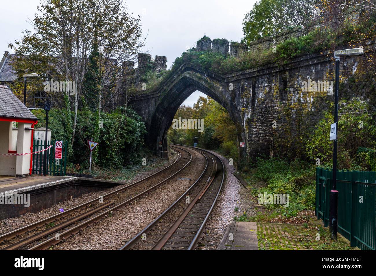 Conwy, railway going through arch in the town walls. Part of the UNESCO ...