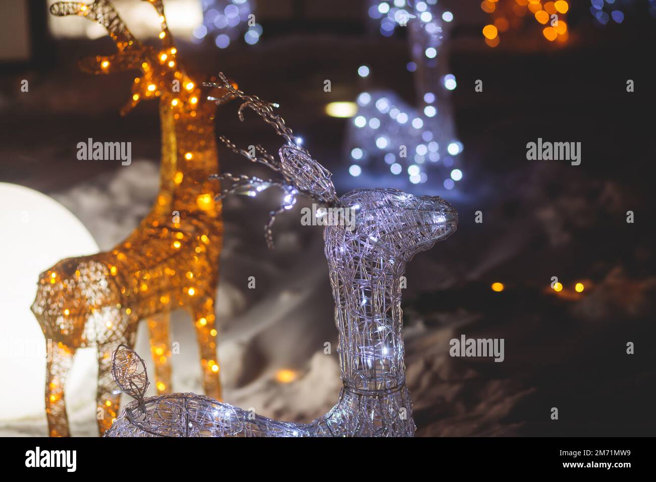 Glowing electric decorations in a winter snowy street, night decor ...