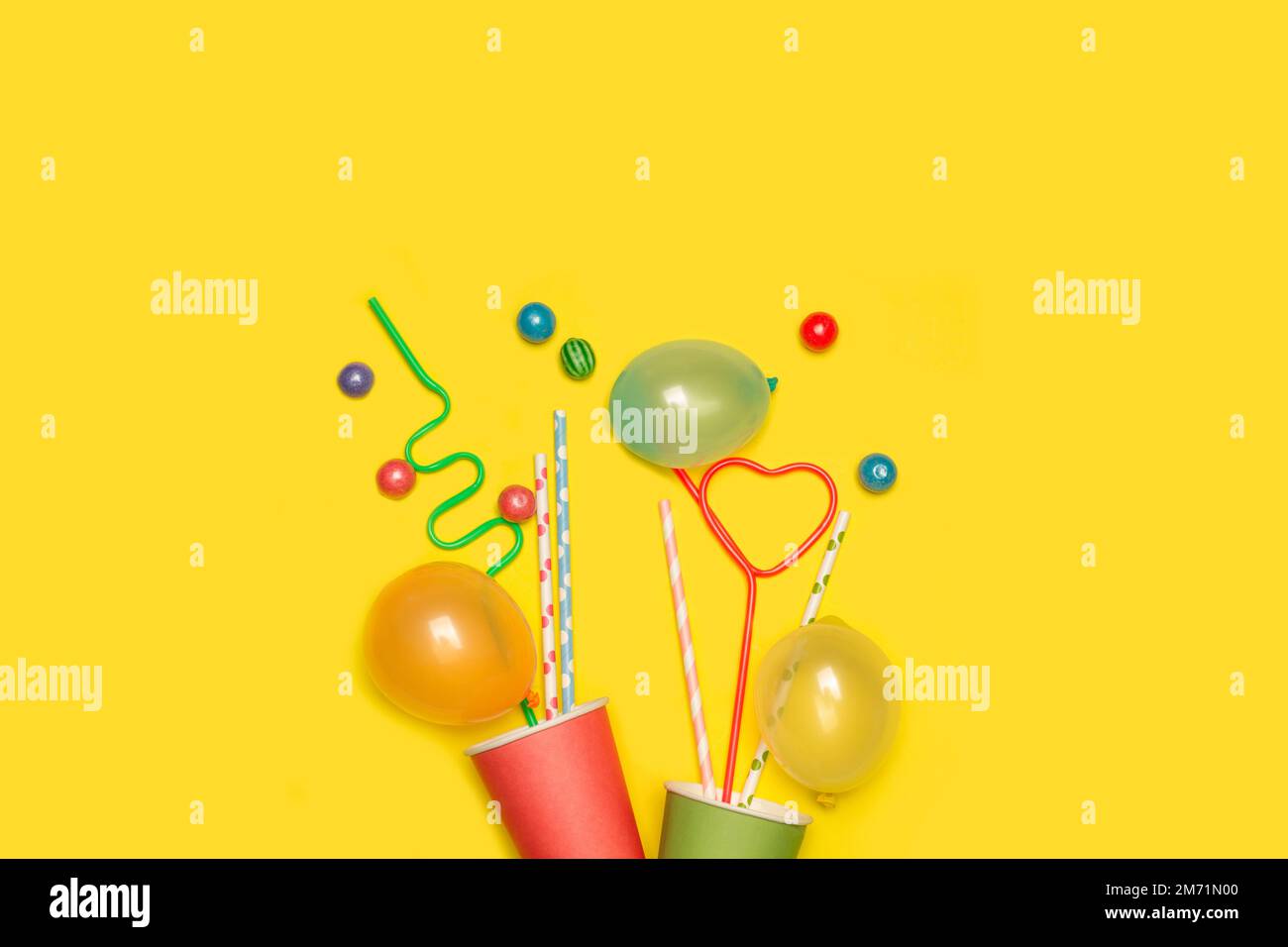 Greeting card with colored disposable cups with straws on a yellow ...