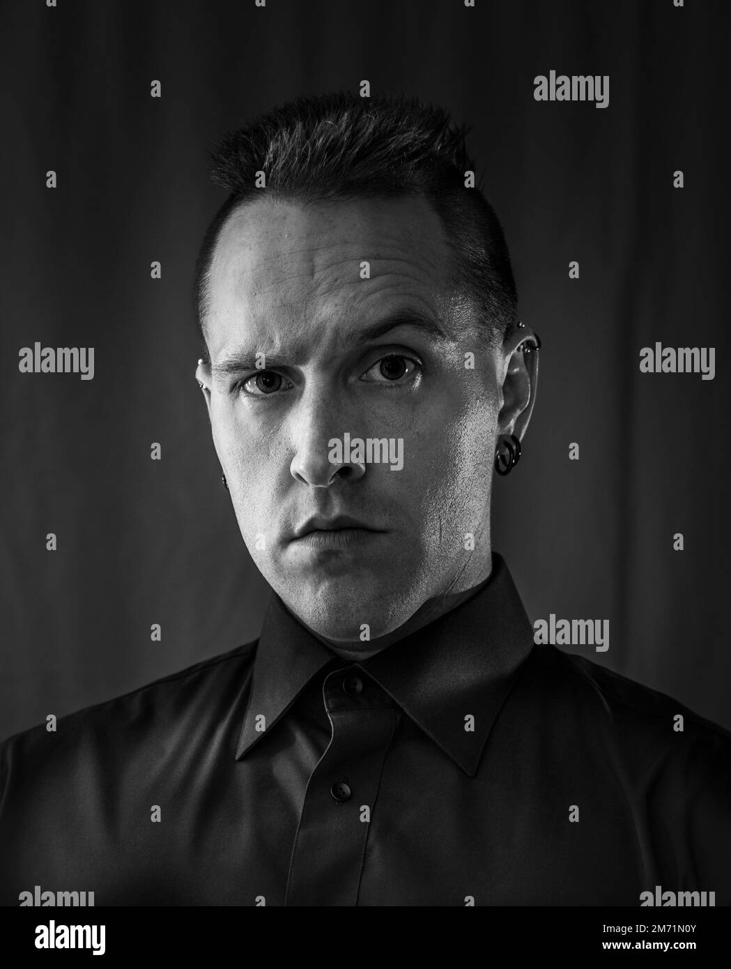 Male modeling headshot in black and white wearing a black button up ...