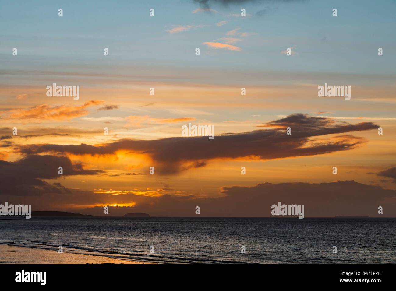 The setting sun lighting up the horizon Stock Photo - Alamy