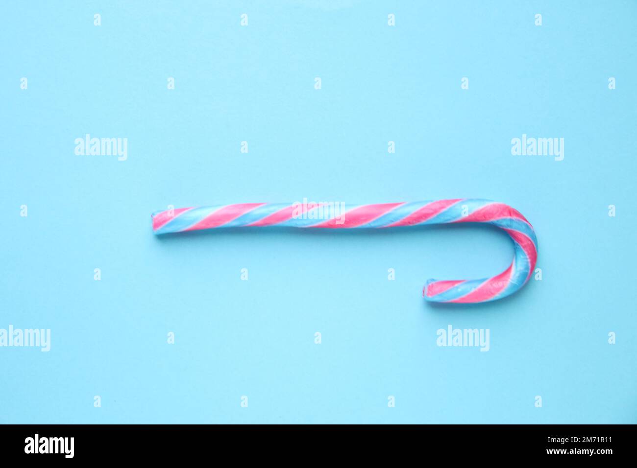 Merry Christmas card. Candy cane on a blue background Stock Photo - Alamy