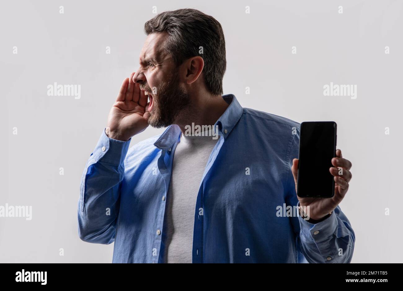 photo of yelling man showing phone app. man showing phone app isolated ...