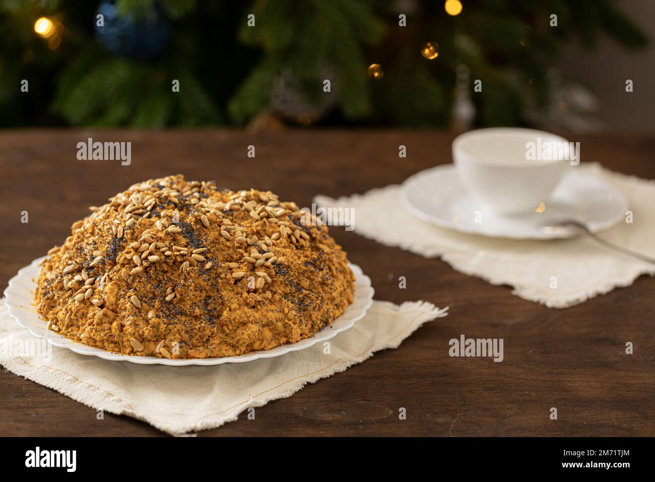 ant hill cake decorated with poppy seeds on a white plate. the concept ...