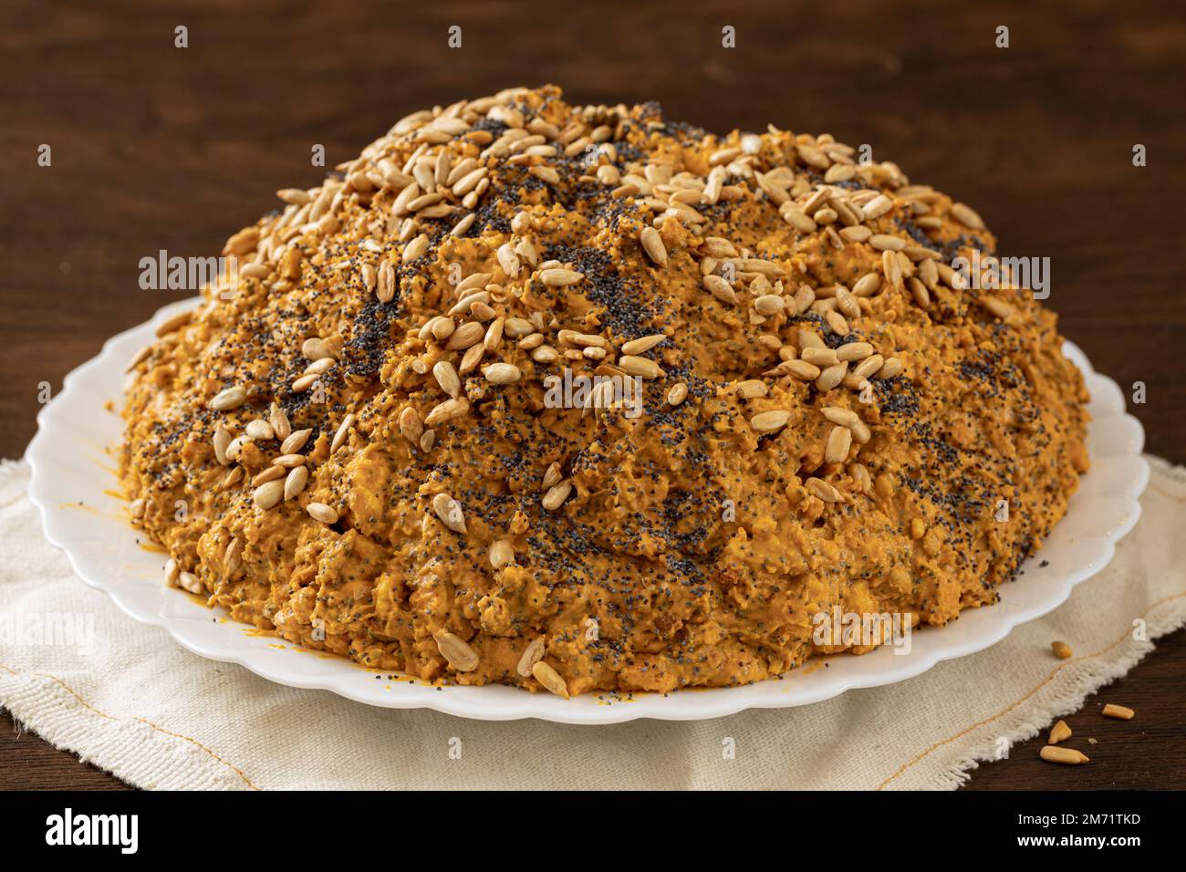 ant hill cake decorated with poppy seeds on a white plate. the concept ...