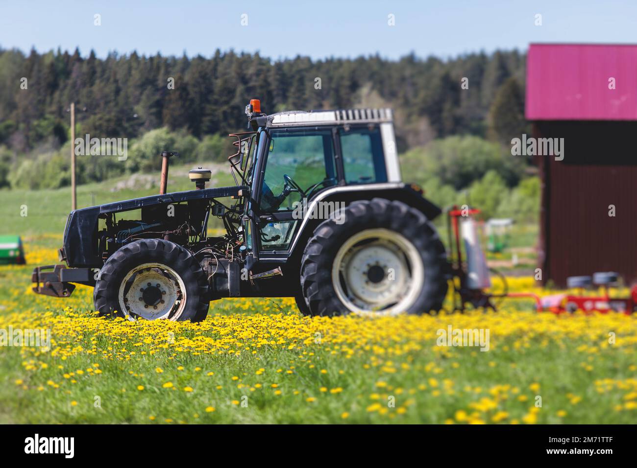 Tractor with a disc harrow system on the cultivated farm field, process ...
