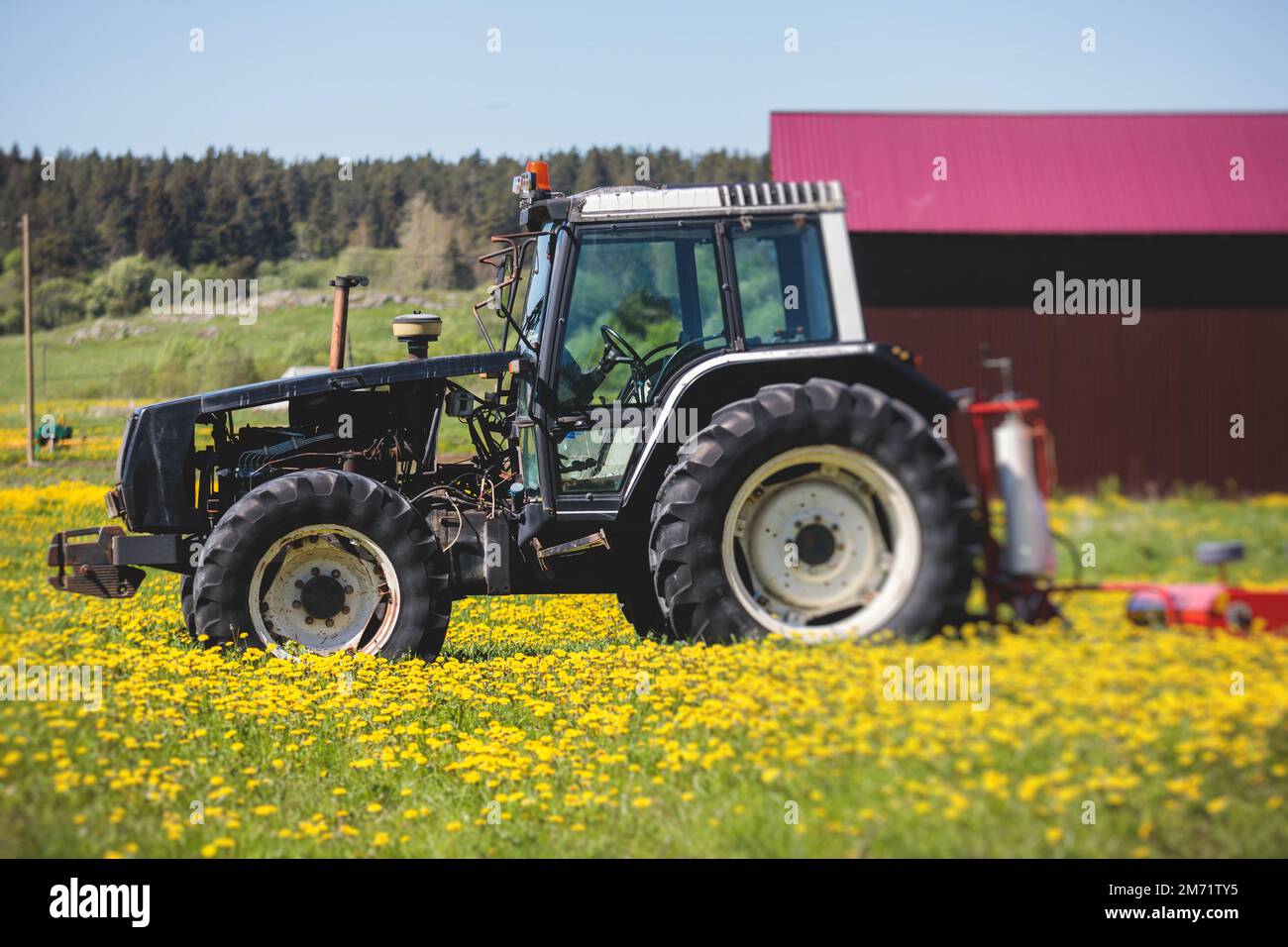 Tractor with a disc harrow system on the cultivated farm field, process ...