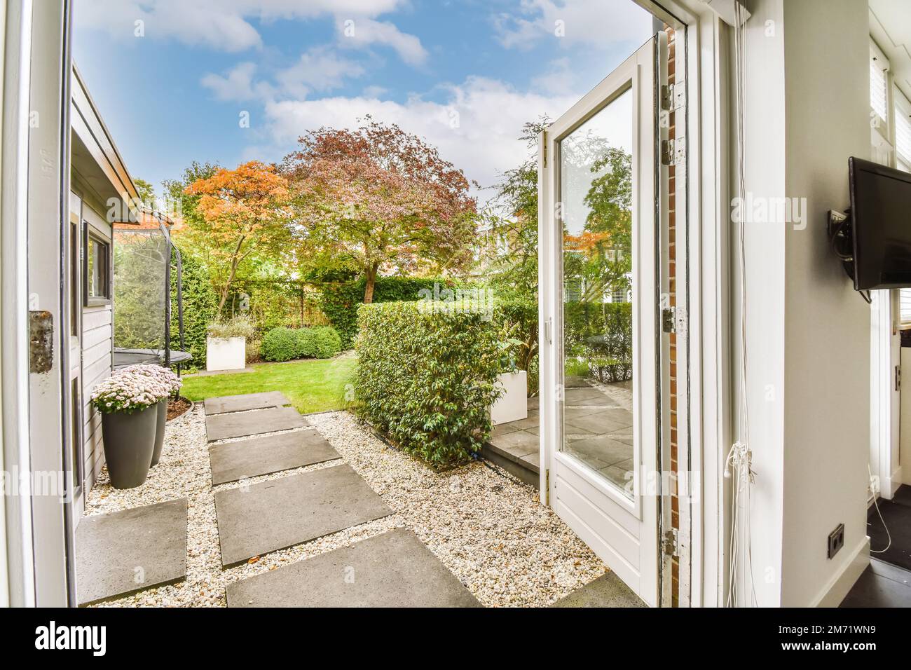 the outside of a house from inside an open door looking out onto a ...