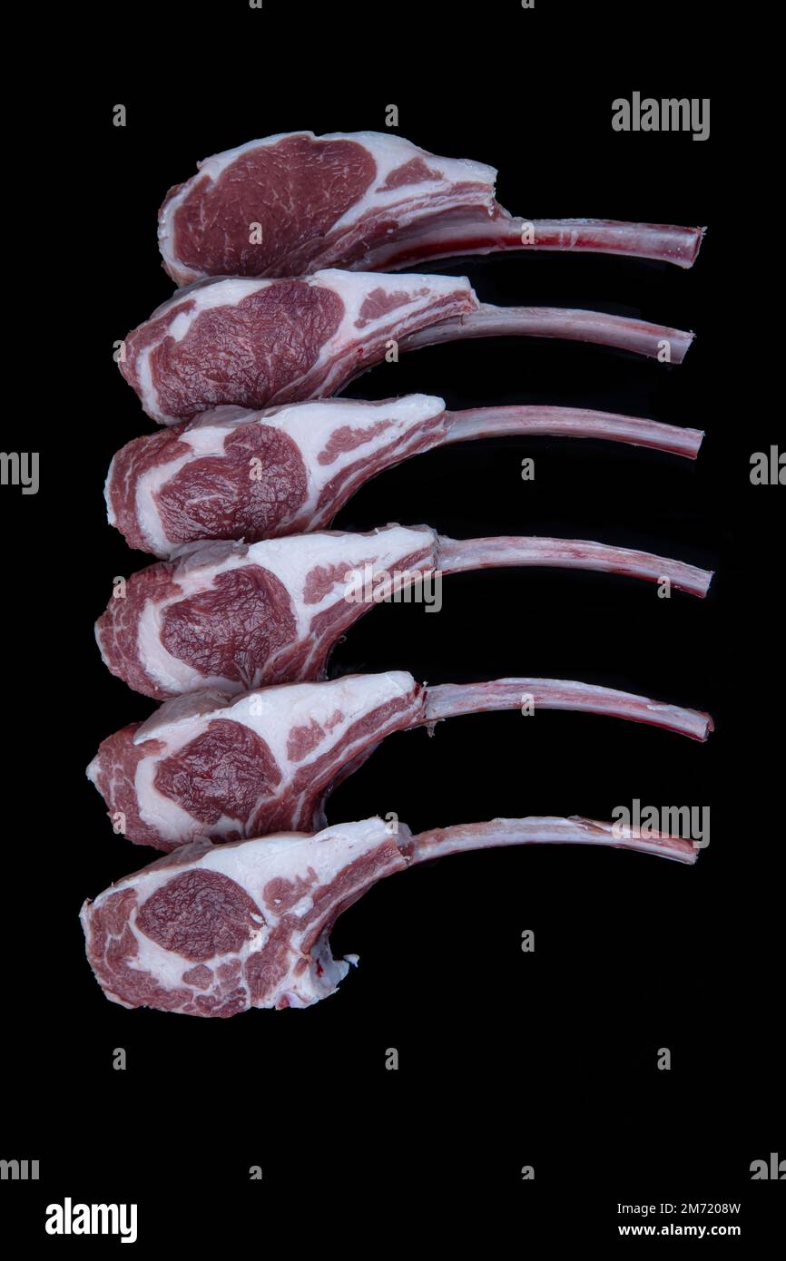 Raw fresh lamb ribs on dark background, close-up. Raw lamb chops. Rack ...