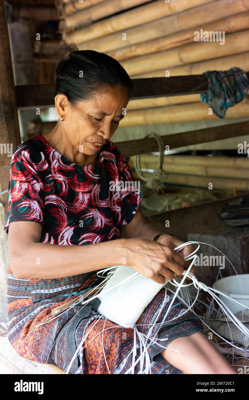 A woman weaves in this traditional Sumbanese village Stock Photo - Alamy