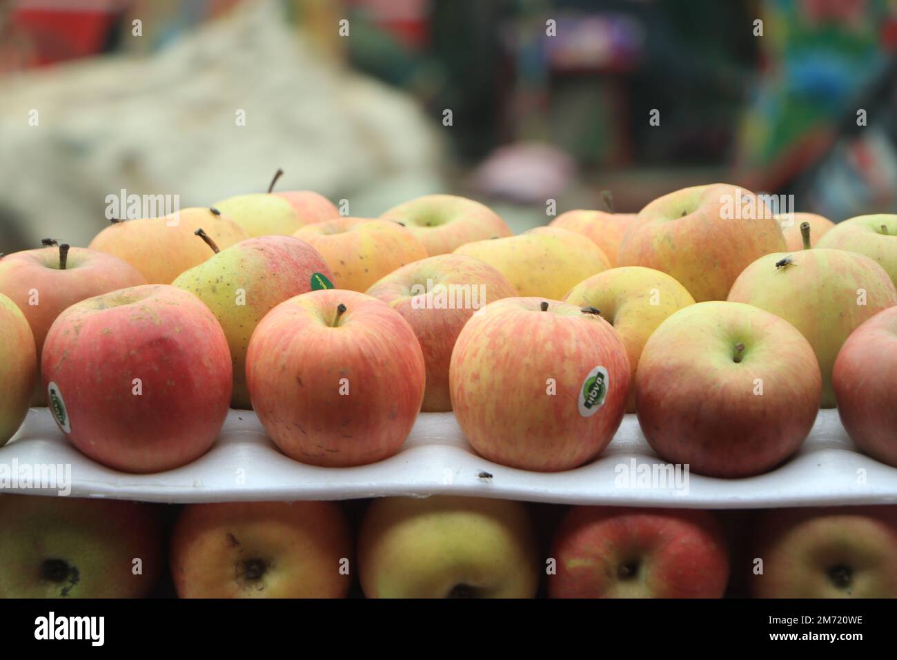 Red apples of the Jonagold variety on the counter of the farmers market ...