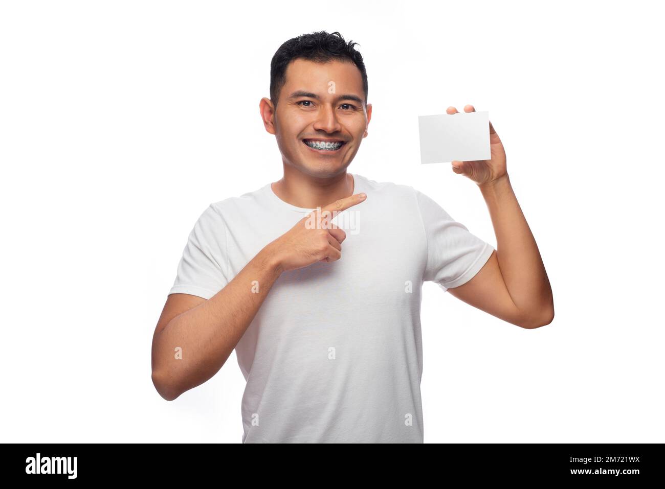 Hispanic-skinned Latino man with orthodontic dental treatment points to ...