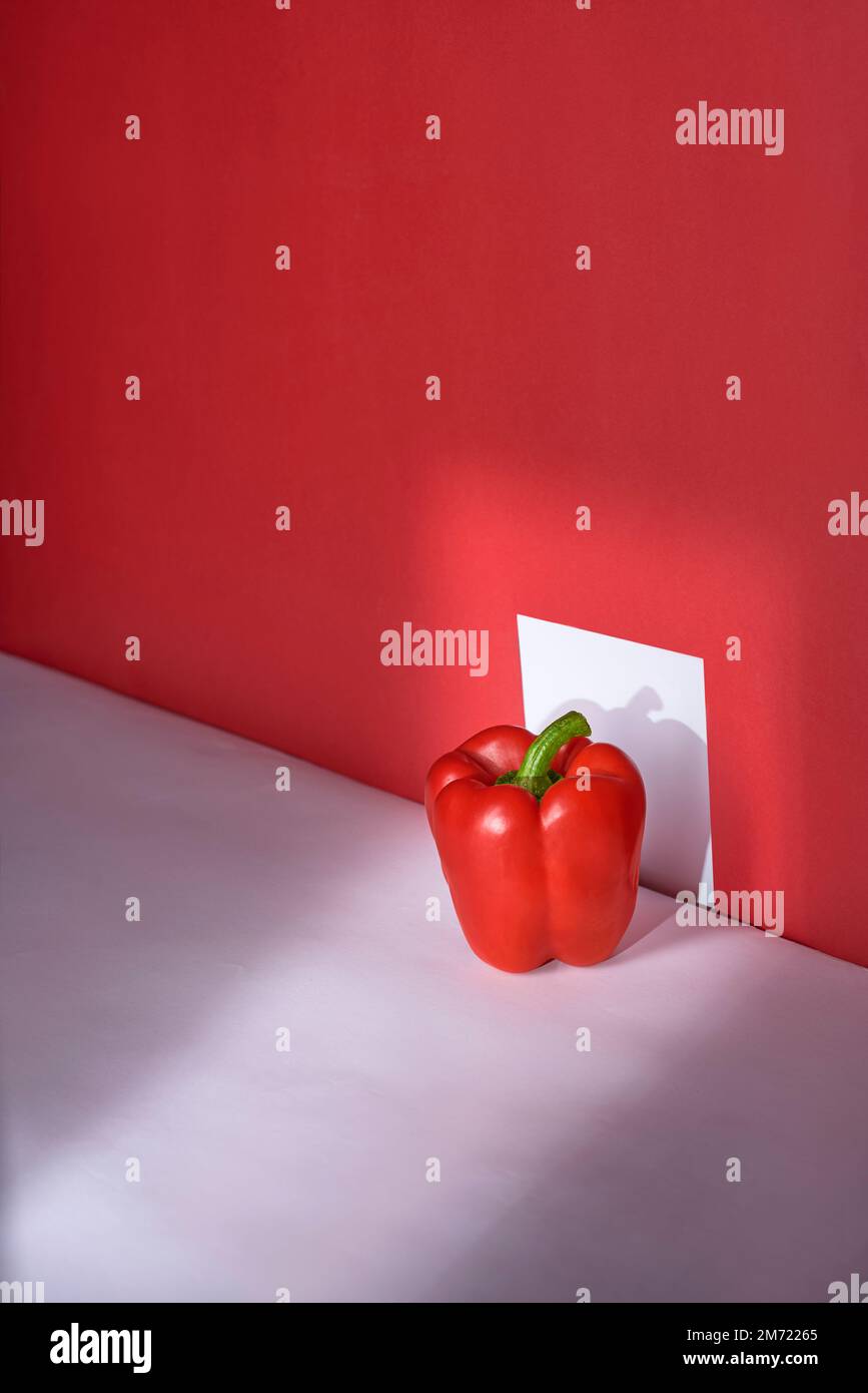 fresh mexican bell pepper only in front of a minimalist red door and ...