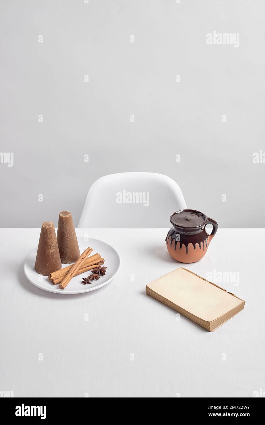 a white table with a white chair in front of a white background, with ...