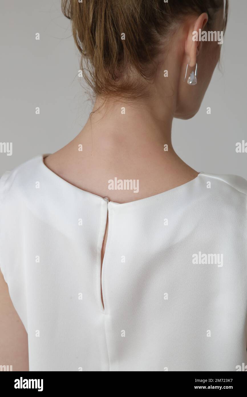 Studio shot of female model wearing white silk sleeveless blousee Stock ...