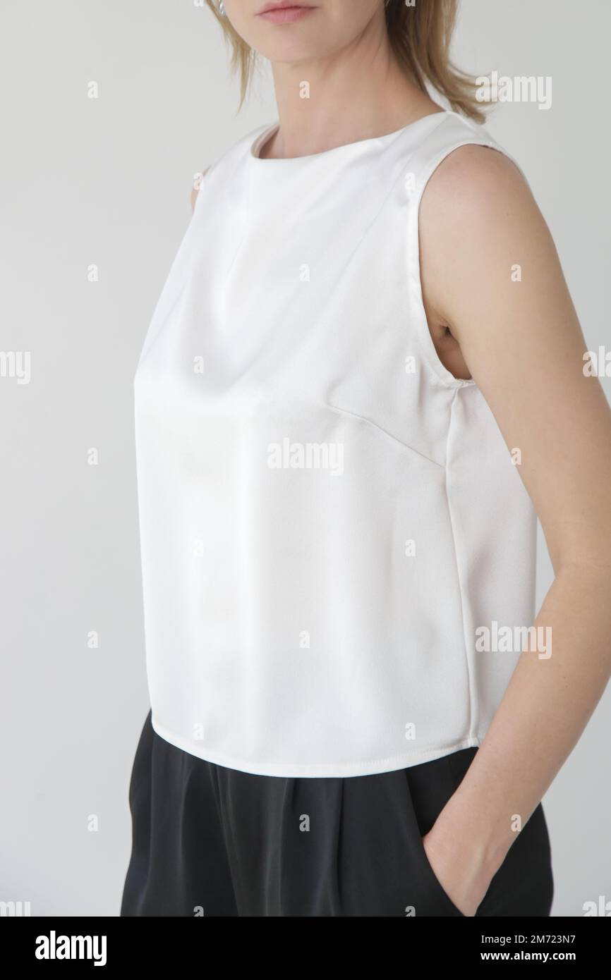 Woman wearing sleeveless white shirt hi-res stock photography and ...