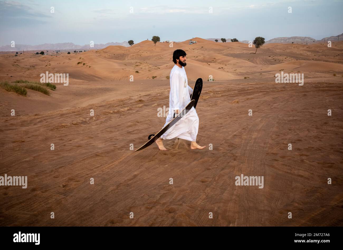 Taipei. 31st Dec, 2022. A sand surfer carries a board while walking ...