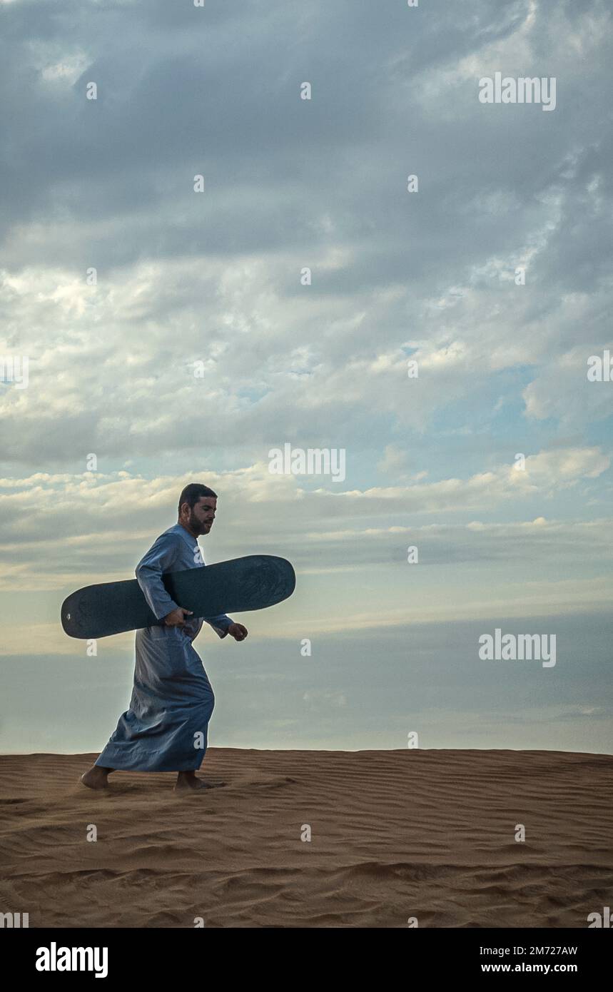 Taipei. 31st Dec, 2022. A sand surfer carries a board while walking ...