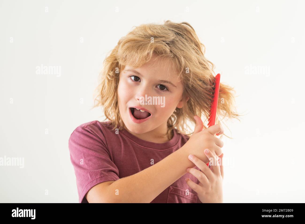 Haircare and kids hair styling. Little child boy combing hair, isolated ...