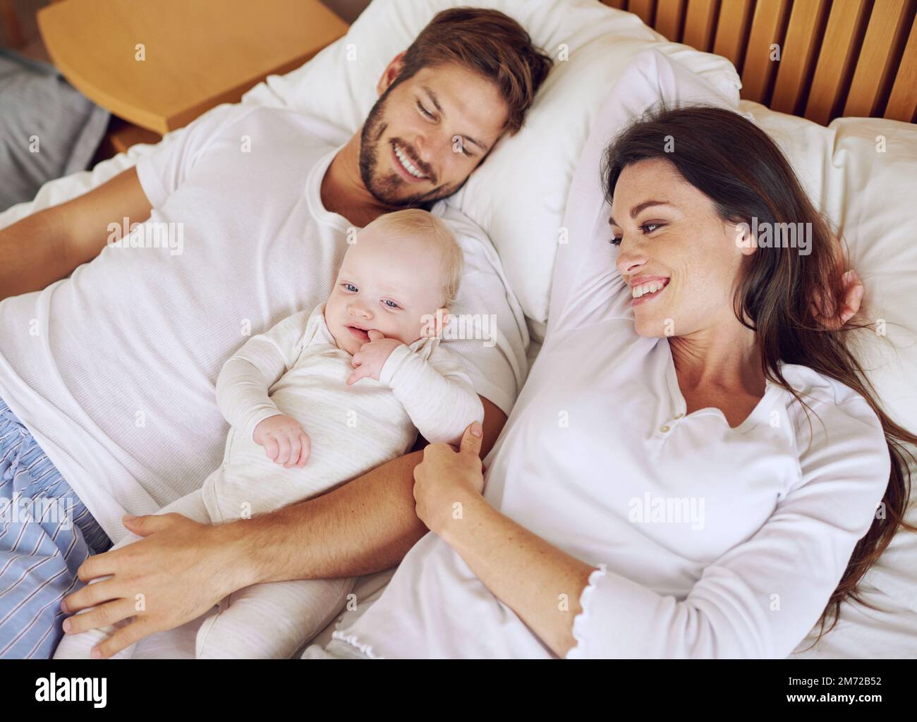 The perfect family. High angle shot of a young couple and their baby ...