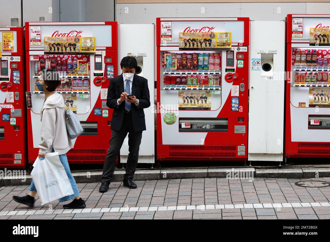 TOKYO, JAPAN - November 24, 2022: A line of drinks vending machines one ...