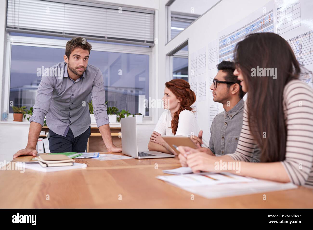 Getting his point across. four coworkers in the boardroom Stock Photo ...