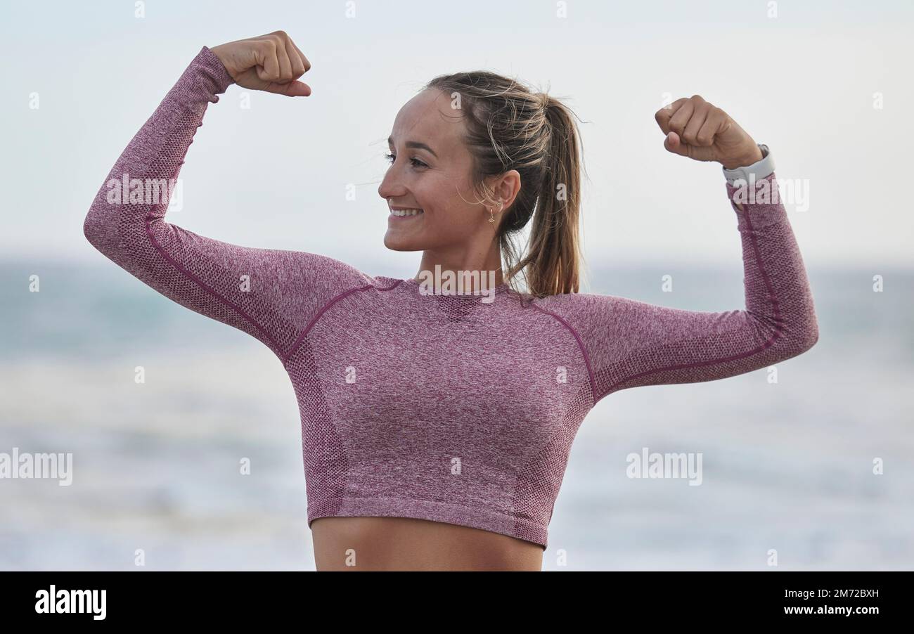 Strong, fitness and woman with muscle flex, exercise on beach and ...