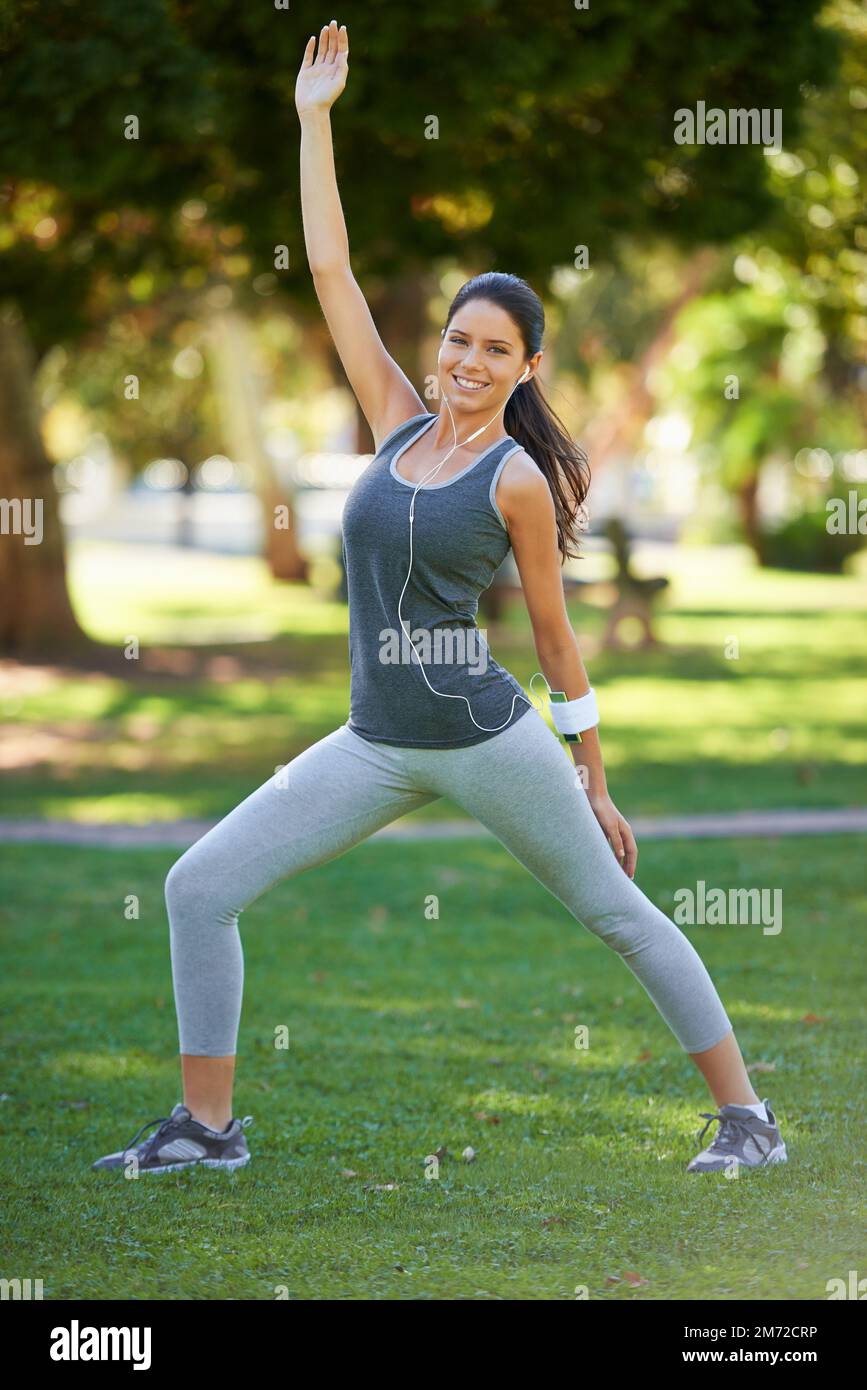 Stretching up to strength. Full length shot of a woman stretching in ...